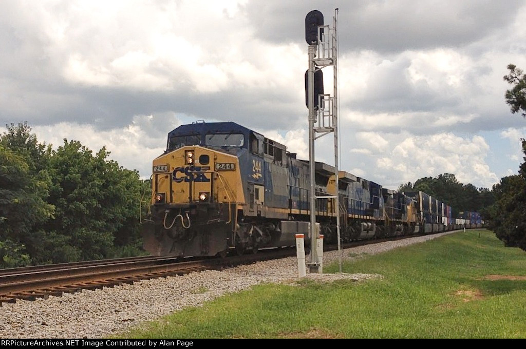 CSX AC44CW 244 leads sister-unit 279, C40-8W 7926, and UP SD70M 4294 past the signals